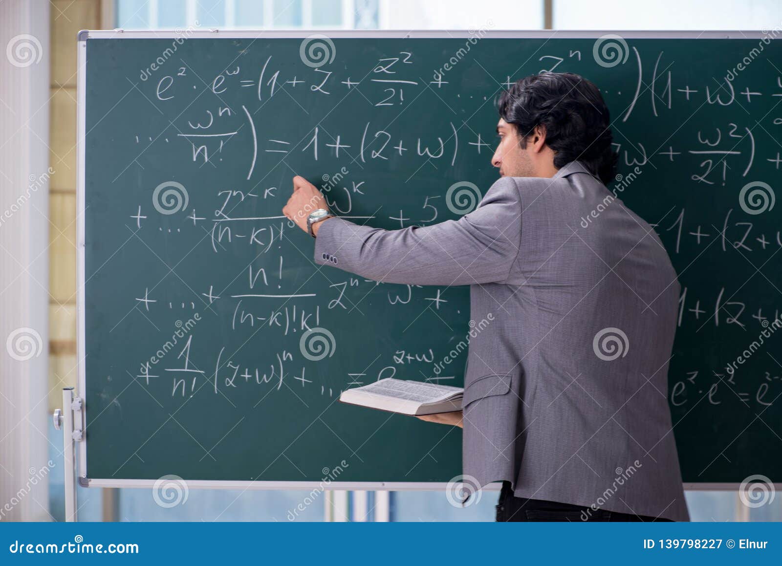 The Young Handsome Math Teacher in Classroom Stock Image - Image of ...