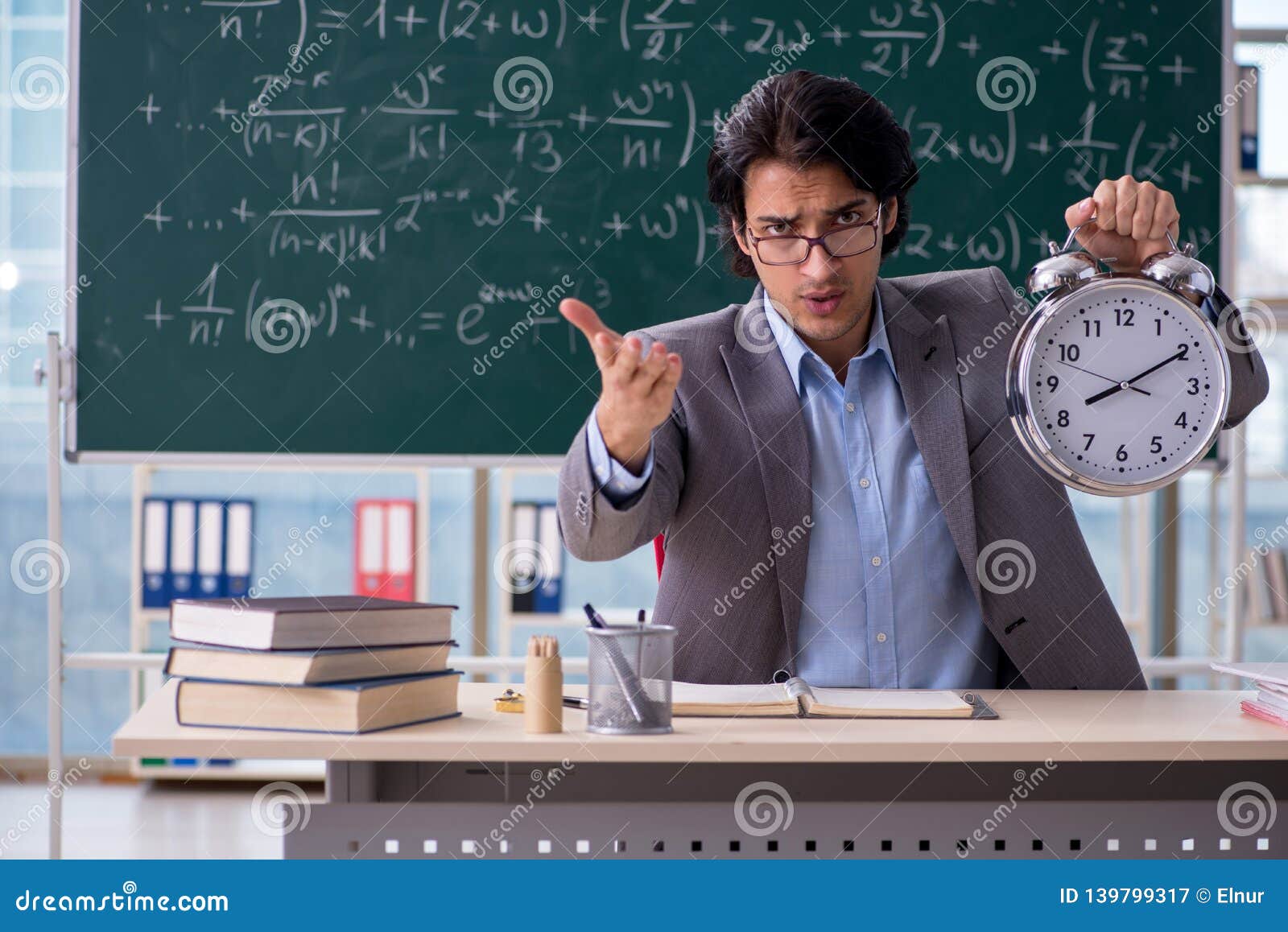 The Young Handsome Math Teacher in Classroom Stock Image - Image of ...