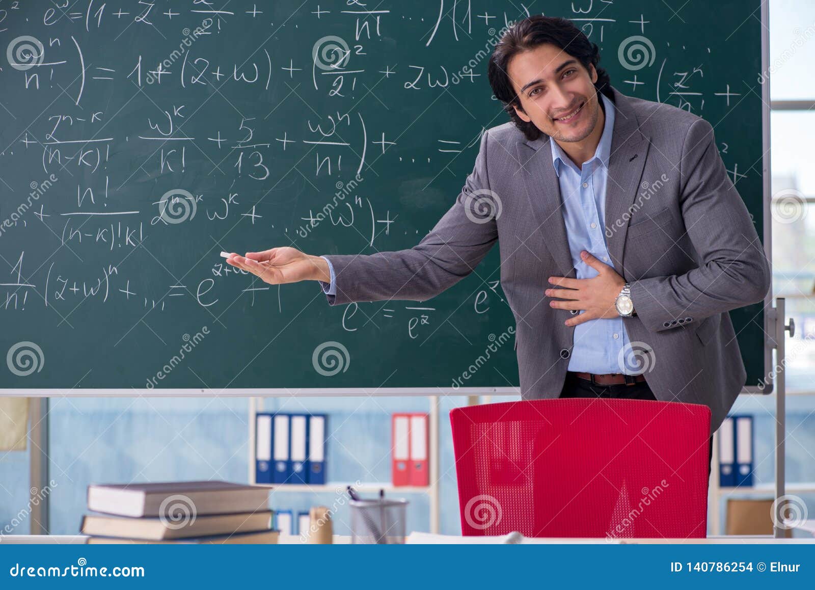 The Young Handsome Math Teacher in Classroom Stock Photo - Image of ...