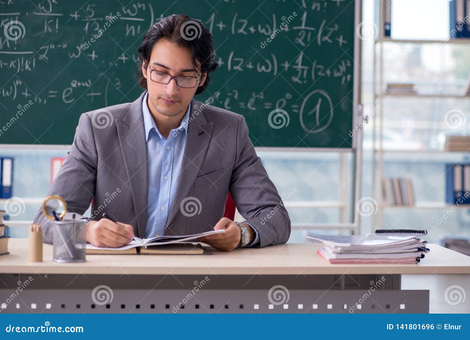 The Young Handsome Math Teacher in Classroom Stock Photo - Image of ...