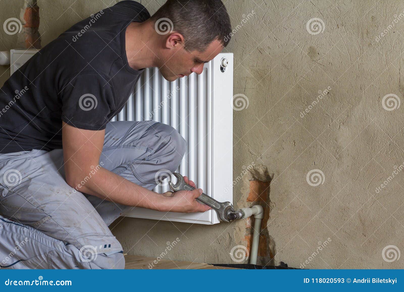 Young Handsome Professional Plumber Worker Installing Heating Ra Stock ...