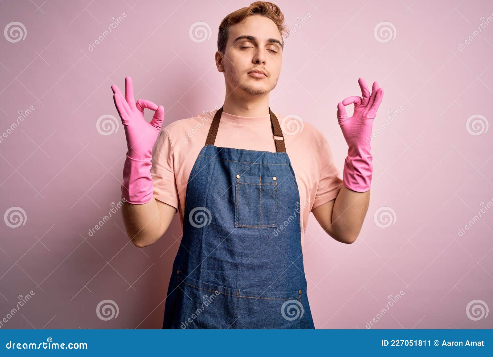 Young Handsome Redhead Cleaner Man Doing Housework Wearing Apron And Gloves Relax And Smiling