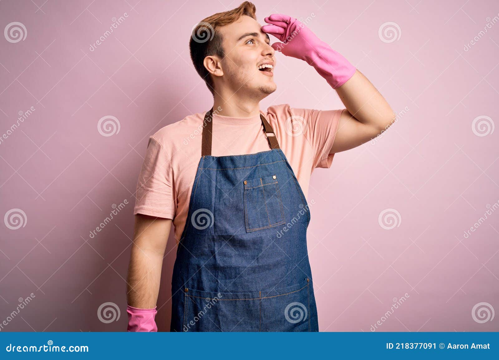 Young Handsome Redhead Cleaner Man Doing Housework Wearing Apron And Gloves Very Happy And