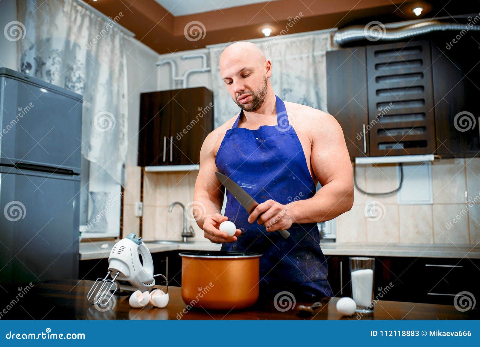 A Young Man is Cooking in a Large Kitchen Stock Image - Image of chef ...