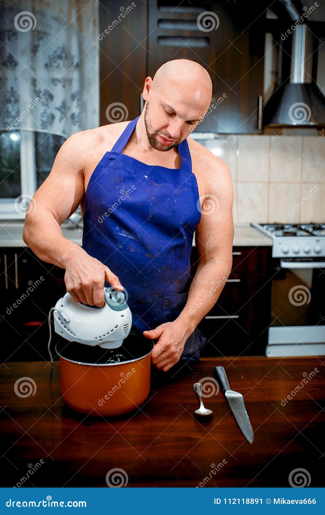 A Young Man is Cooking in a Large Kitchen Stock Image - Image of people ...