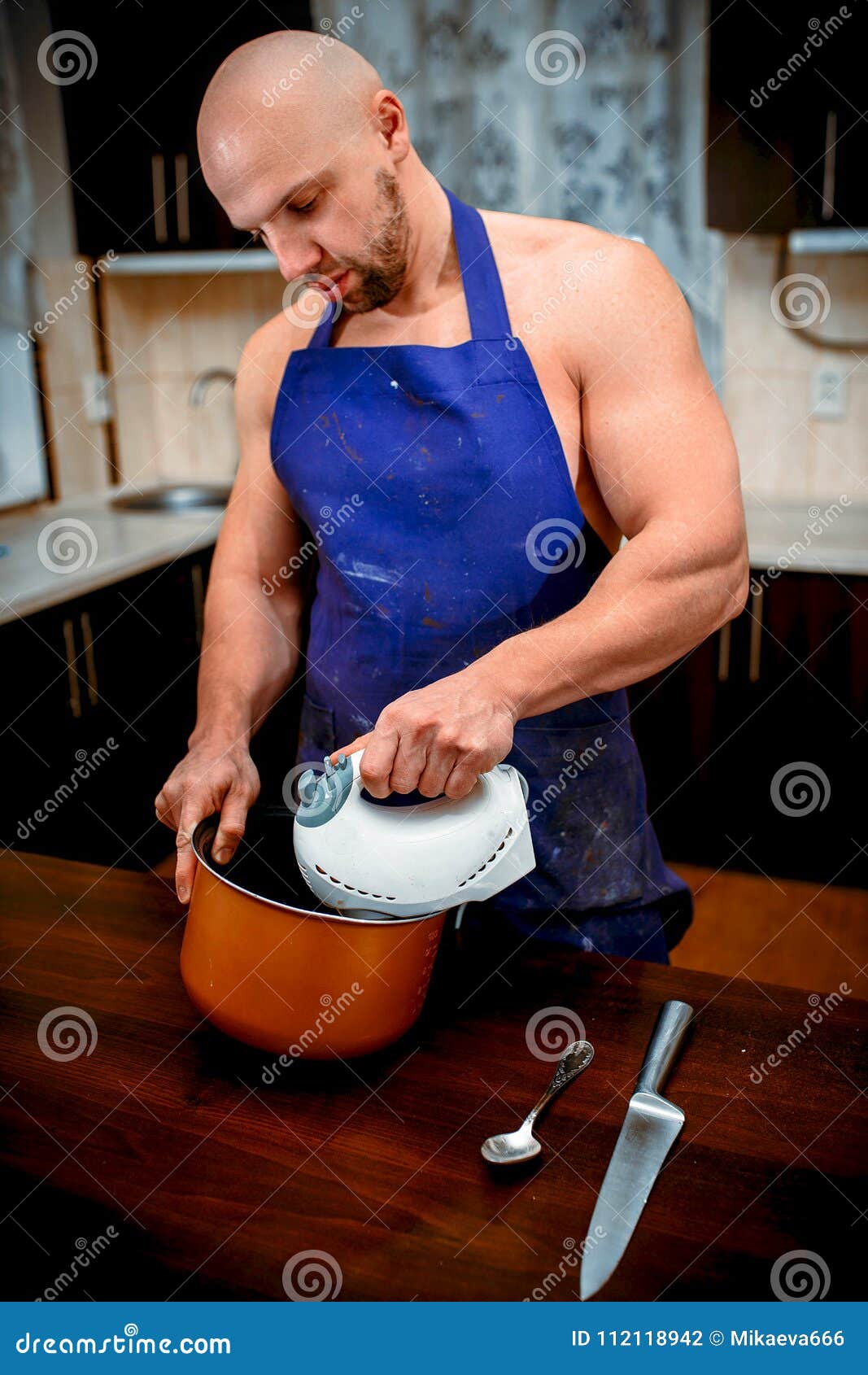 A Young Man is Cooking in a Large Kitchen Stock Photo - Image of dinner ...