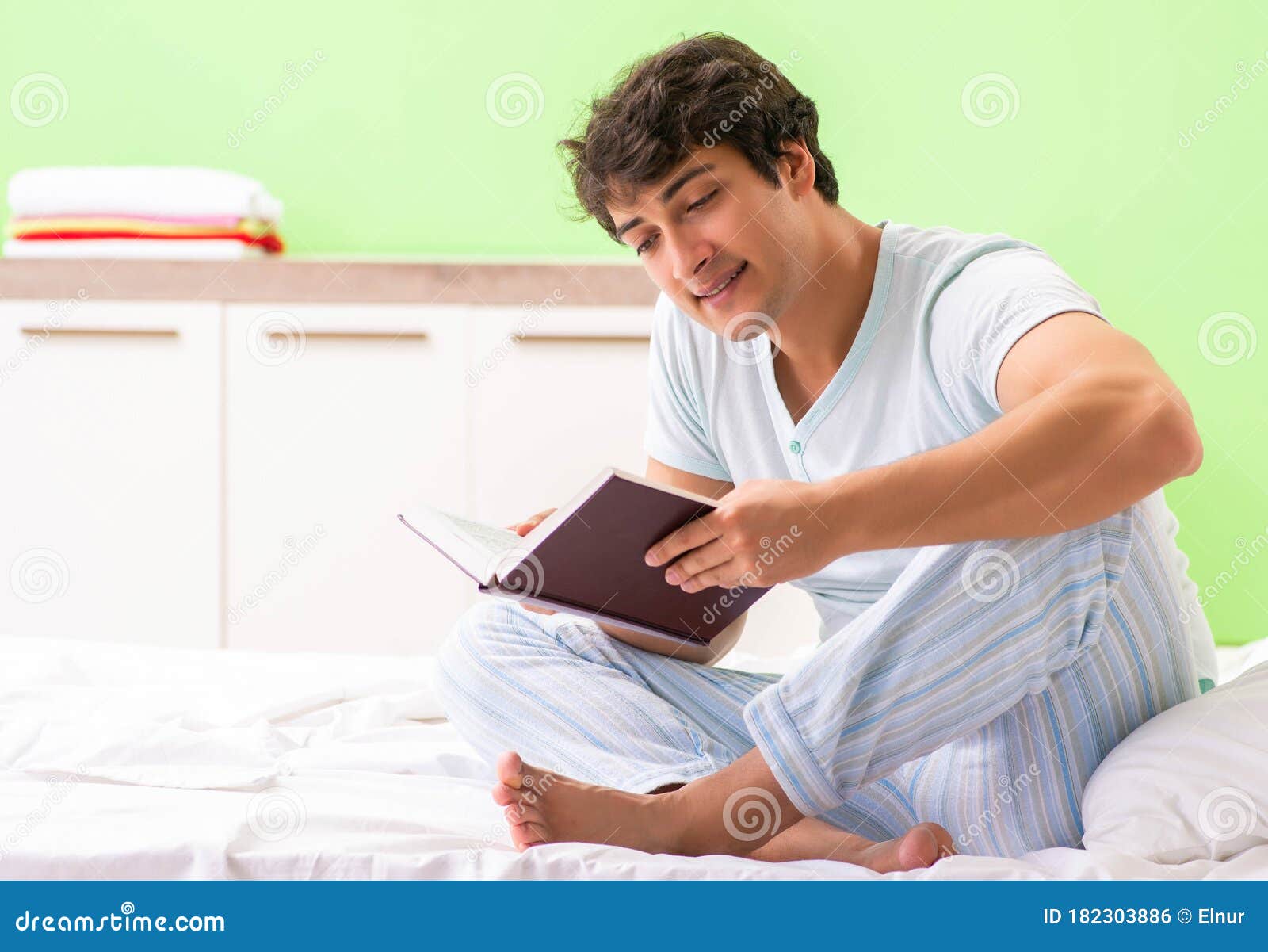 Young Handsome Student Reading Book in the Bed Stock Photo - Image of ...