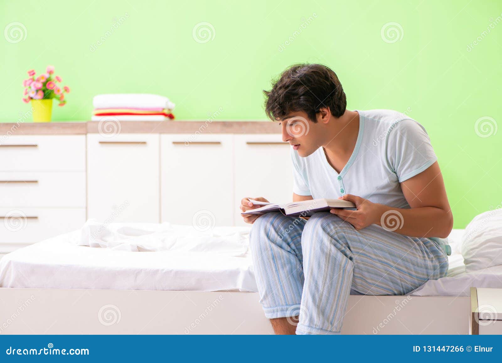 The Young Handsome Student Reading Book in the Bed Stock Photo - Image ...