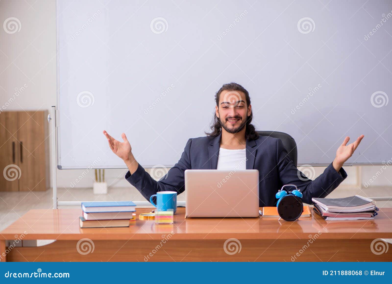 Young Male Teacher in the Classroom Stock Photo - Image of telestudying ...