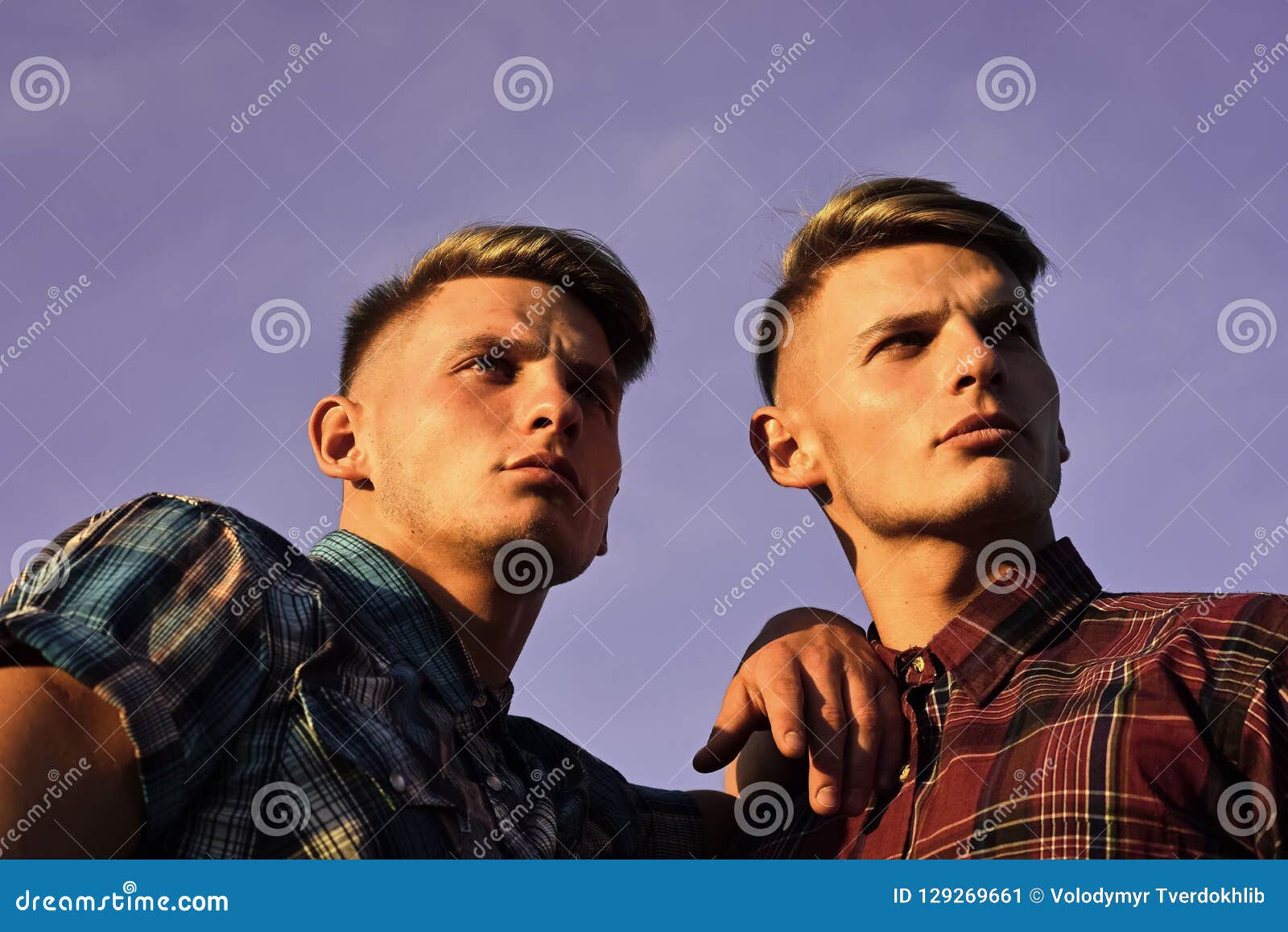 Handsome Twins Posing With Serious Faces On Sky Background Stock ...