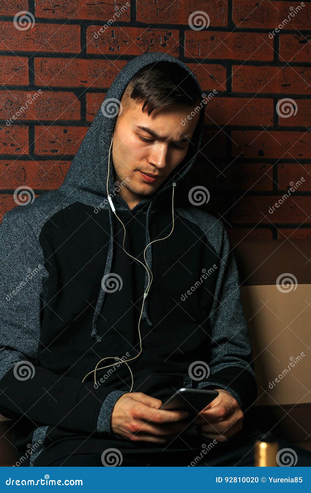 Young Handsome White Guy is Typing Sms on His Phone. Stock Photo ...