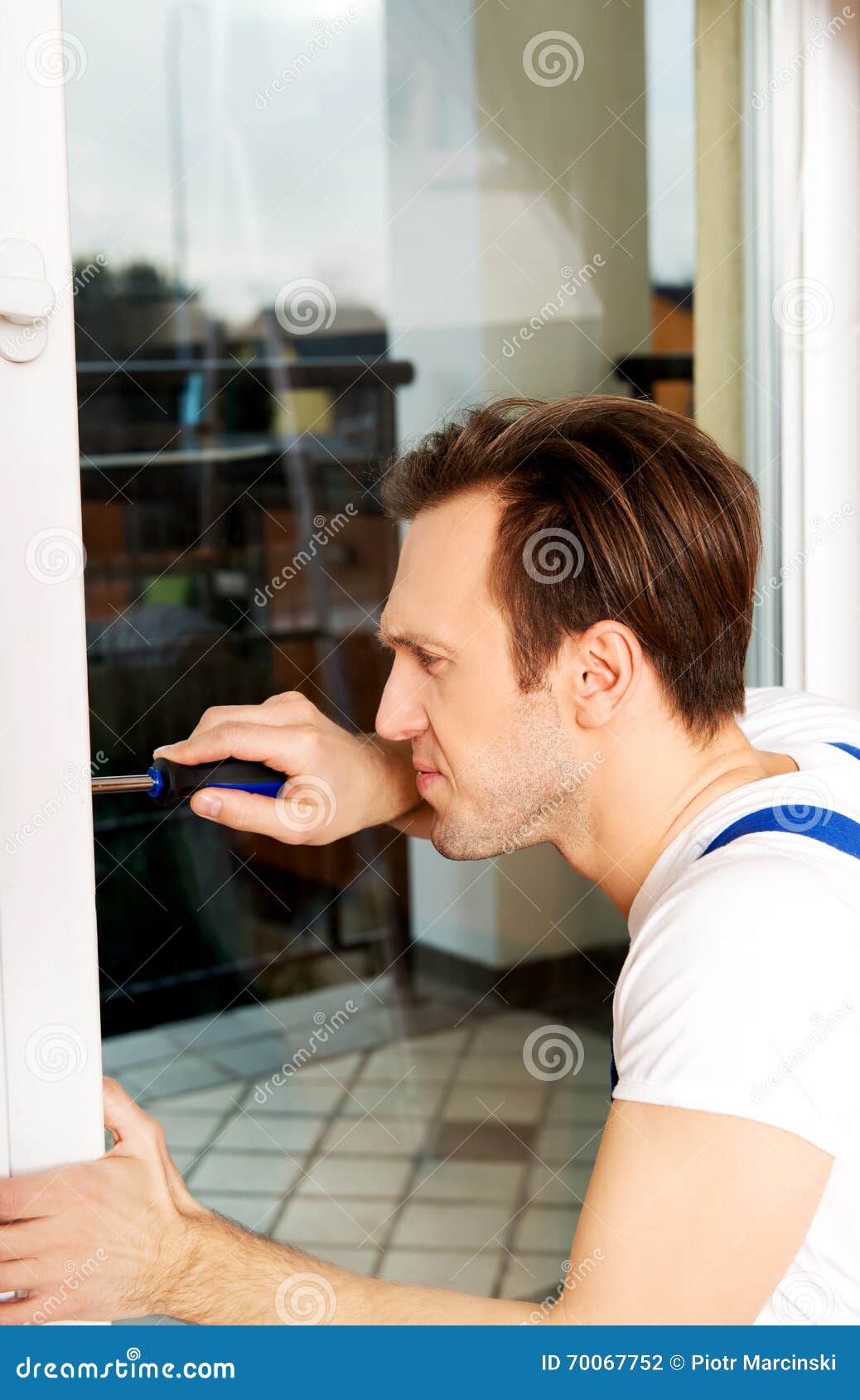 Young Handyman Repair Window with Screwdriver Stock Photo - Image of ...