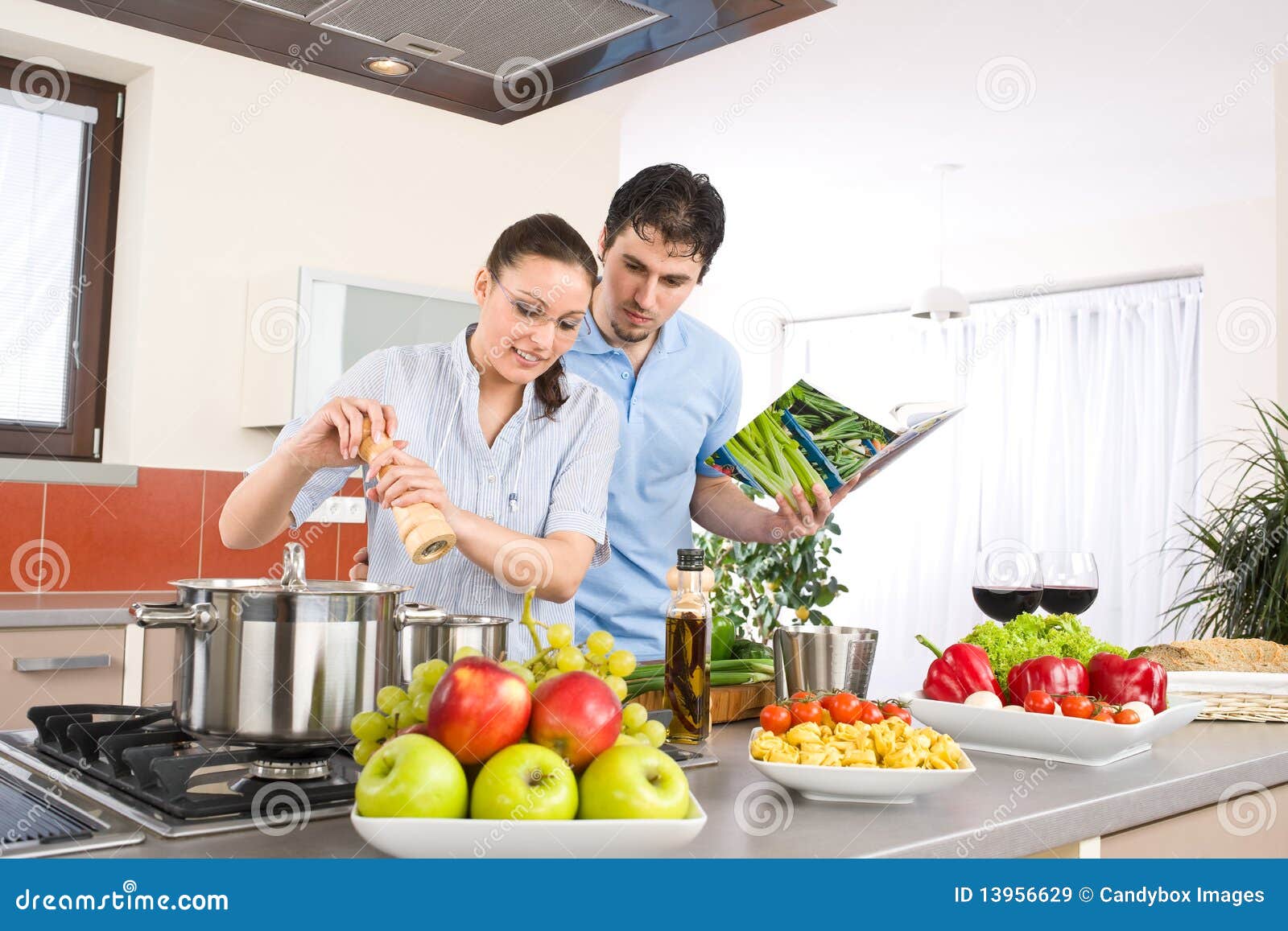 Young Happy Couple Cook in Kitchen with Cookbook Stock Image - Image of ...