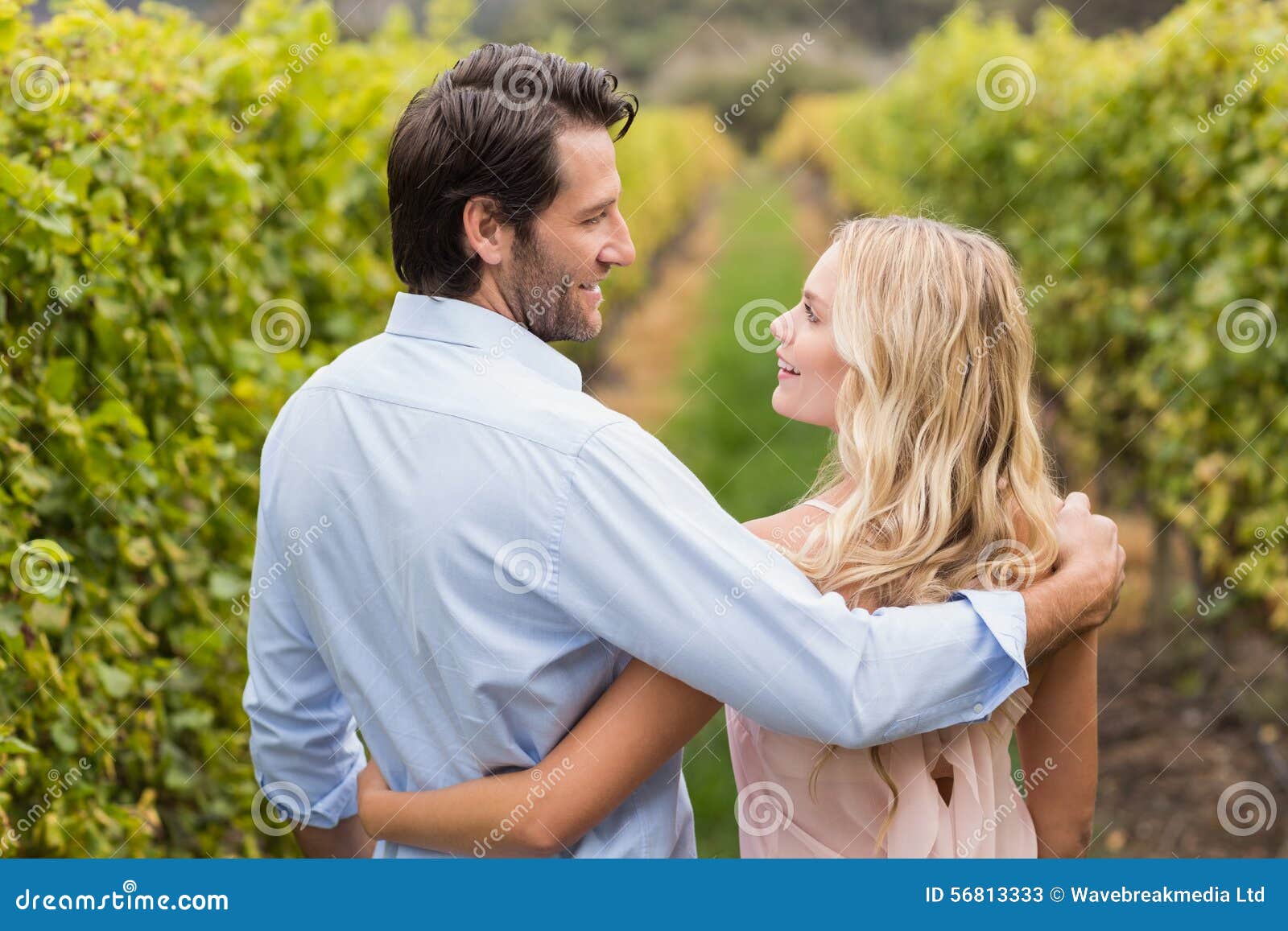 Young Happy Couple Having An Arm Around Each Other And Smiling Stock