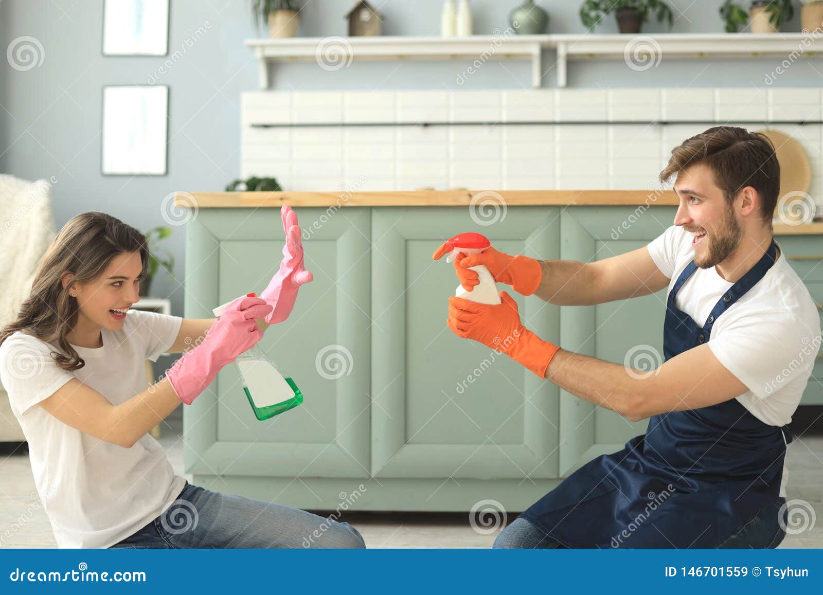 Young Happy Couple is Having Fun while Doing Cleaning at Home Stock ...