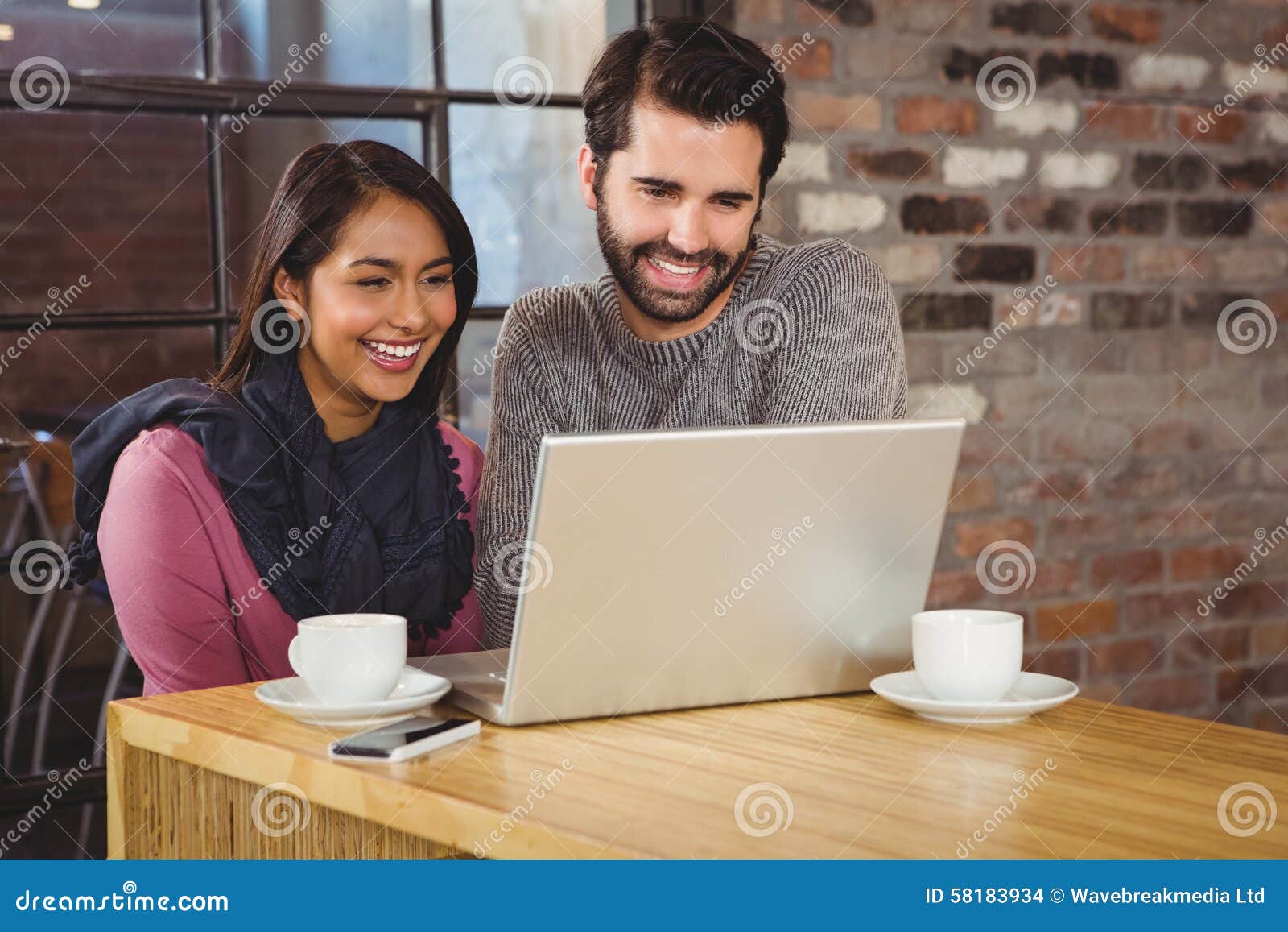 Young Happy Couple Looking at a Laptop Stock Photo - Image of fashion ...
