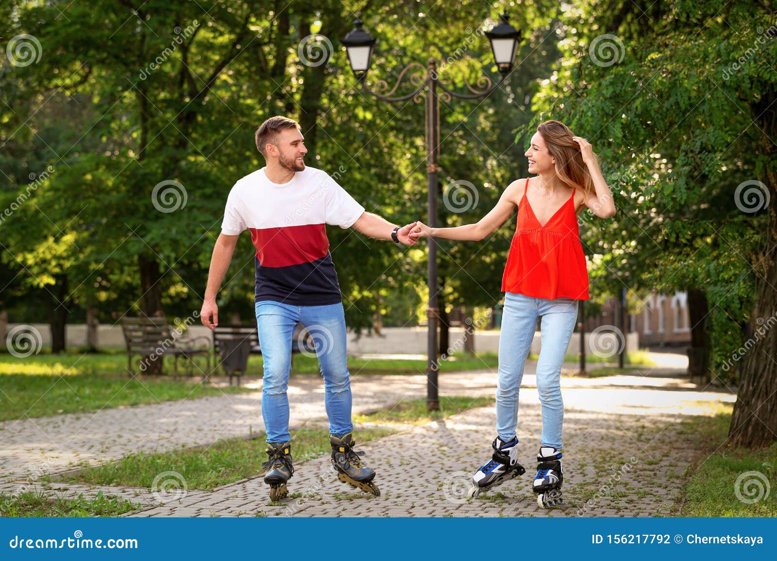 Young Happy Couple Roller Skating in Summer Stock Photo - Image of ...