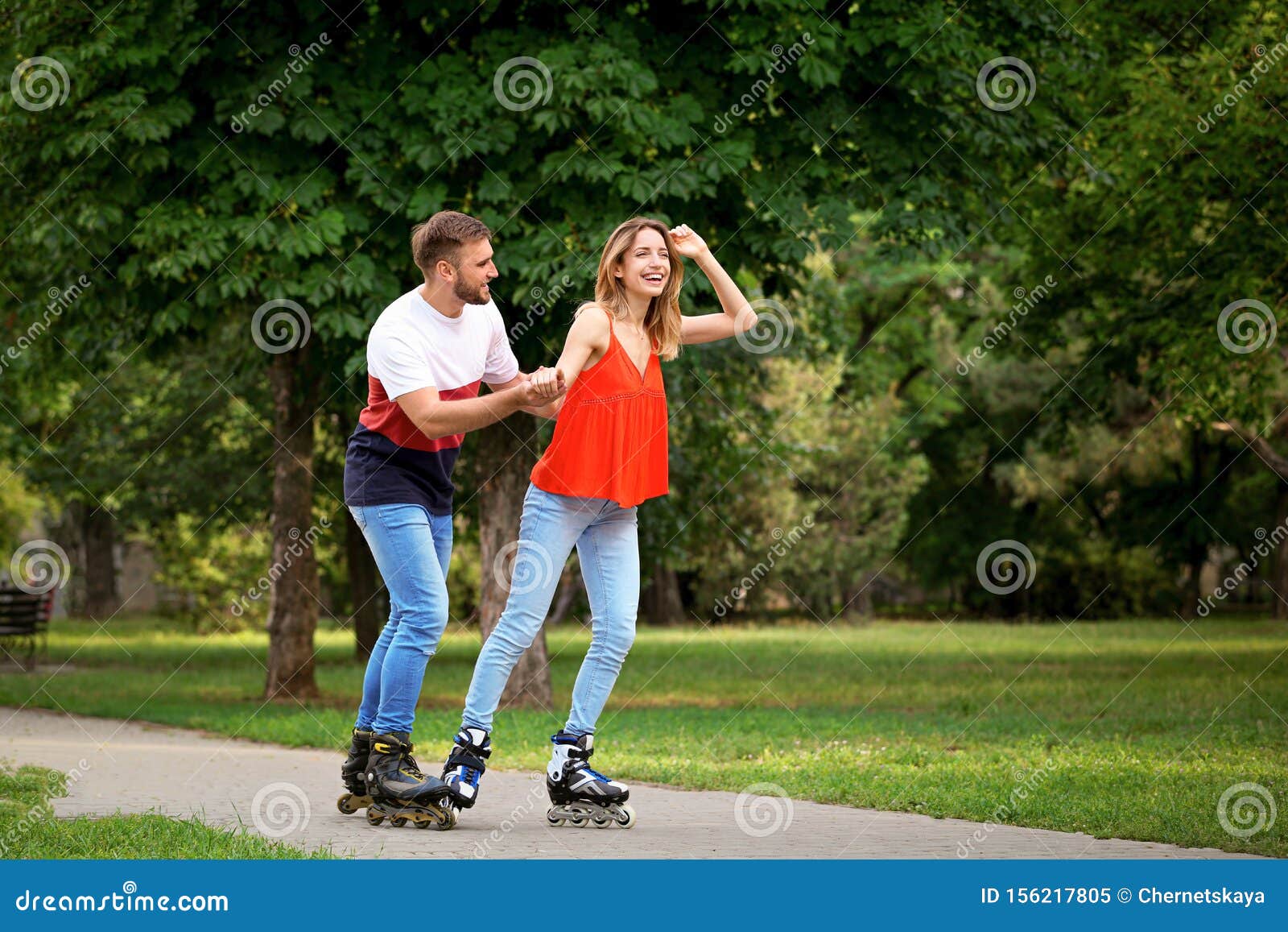 Young Happy Couple Roller Skating in Park Stock Image - Image of ...