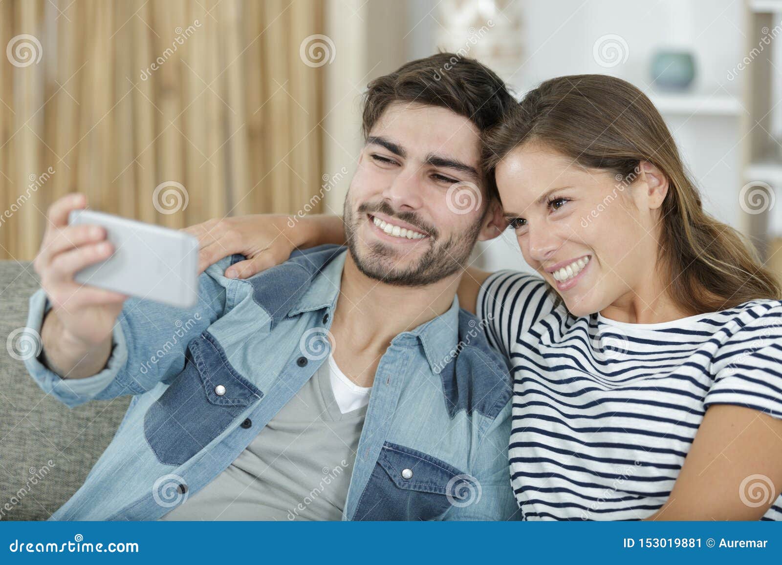 Young Happy Couple Taking Selfie On Sofa Stock Image Image Of Estate