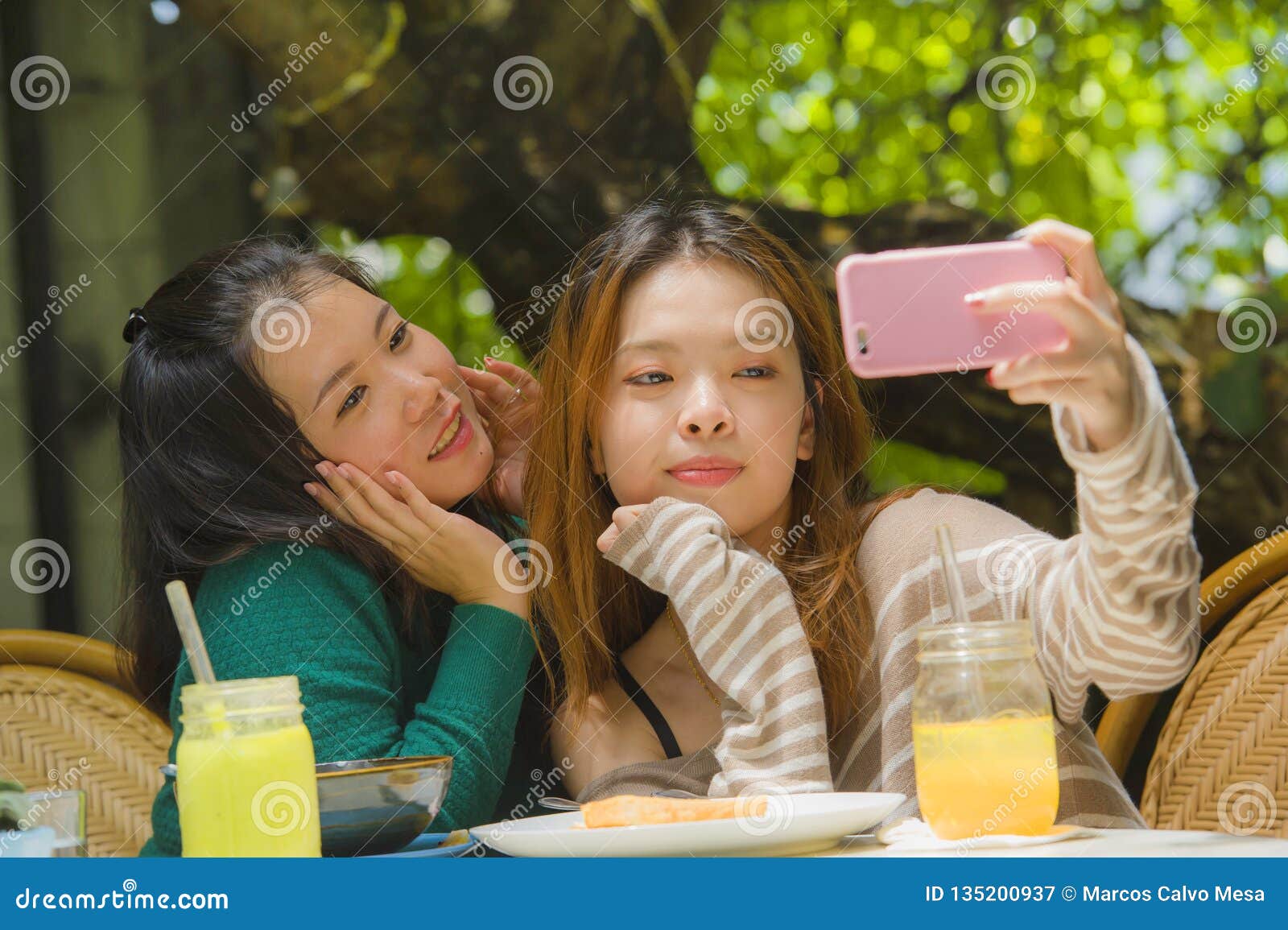 Young Happy And Cute Asian Chinese Girlfriends Taking Selfie Portrait