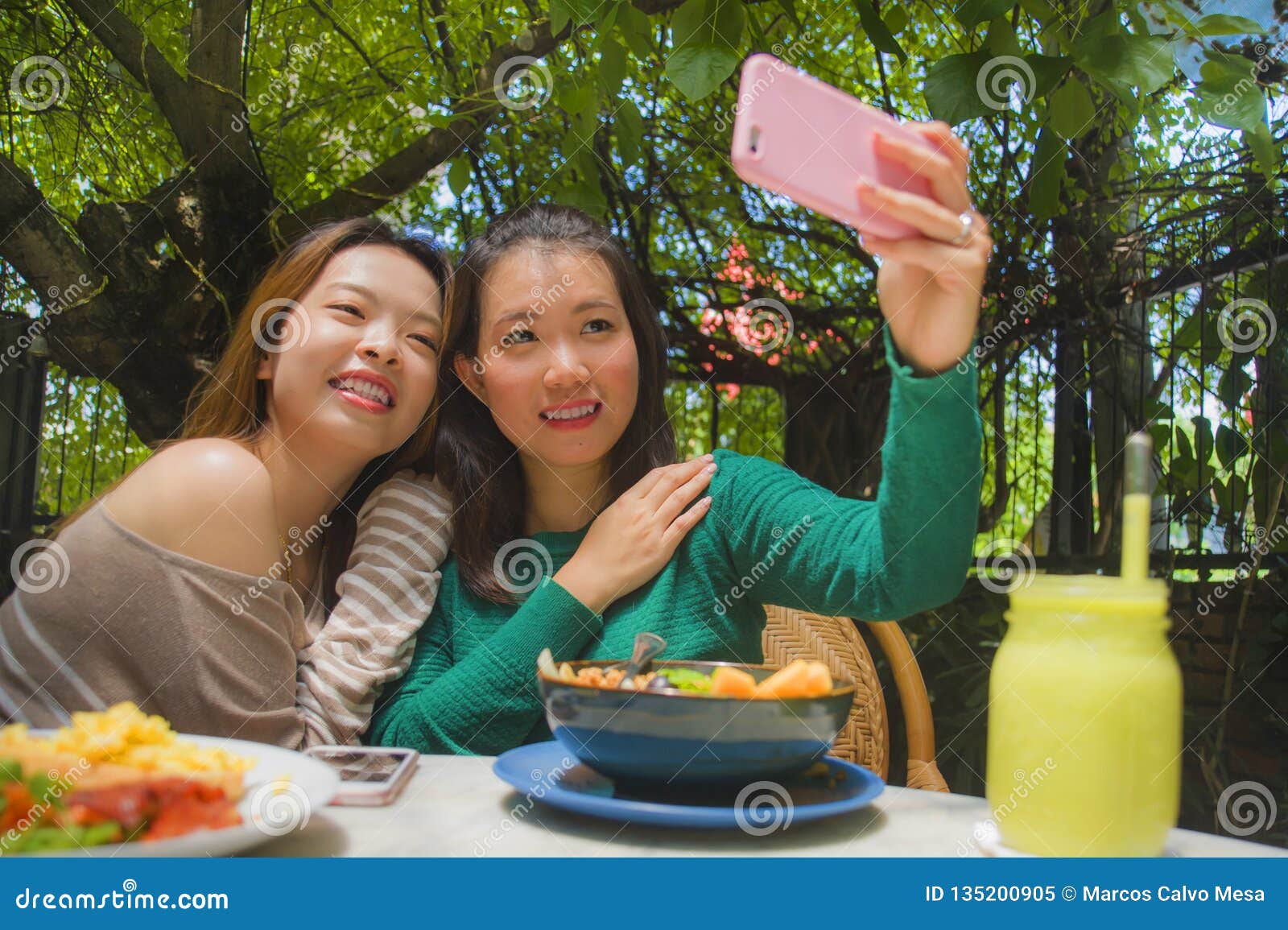 Young Happy And Cute Asian Chinese Girlfriends Taking Selfie Portrait
