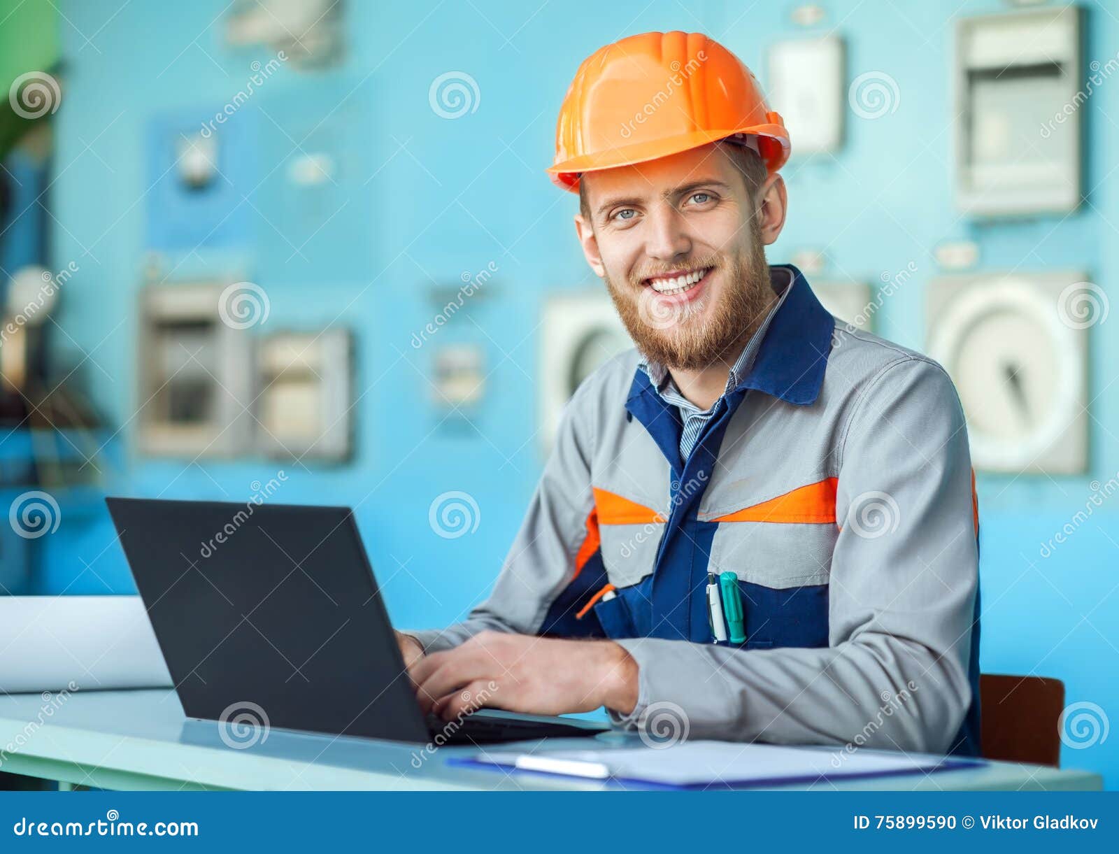 Young Happy Engineer Working at Laptop in Control Room Stock Photo ...