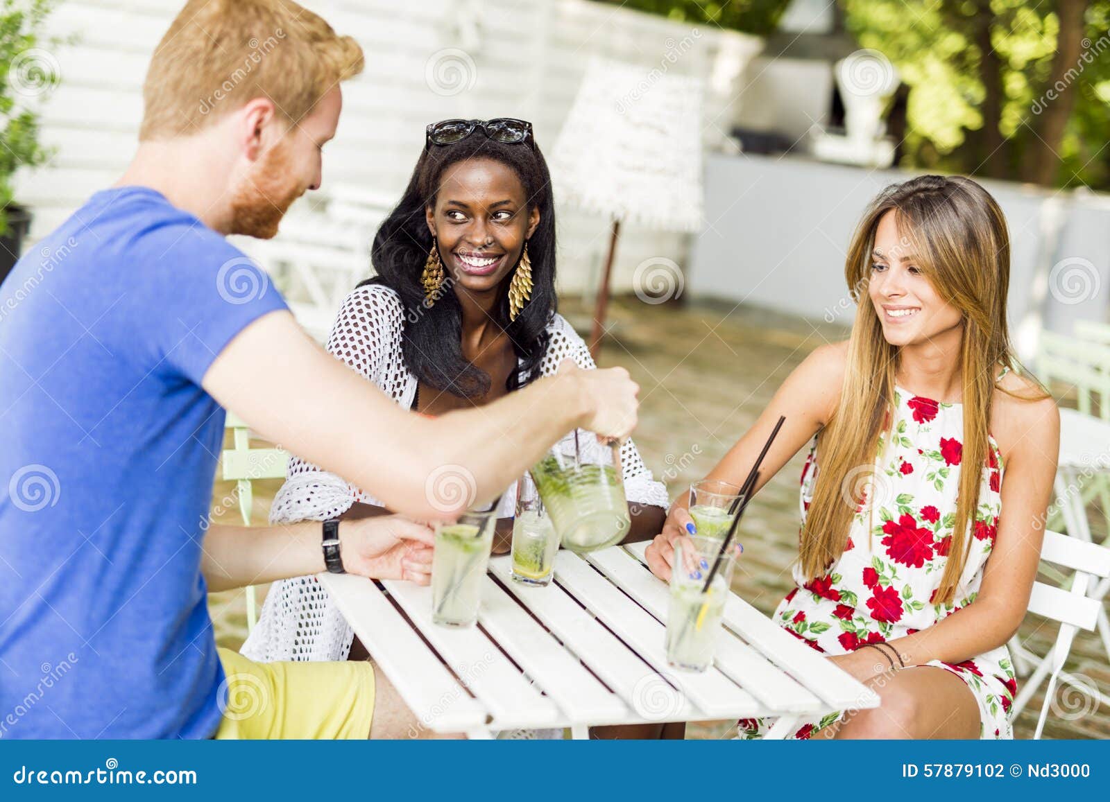 Young and Happy Friends Sitting Talking at a Table Stock Photo - Image ...