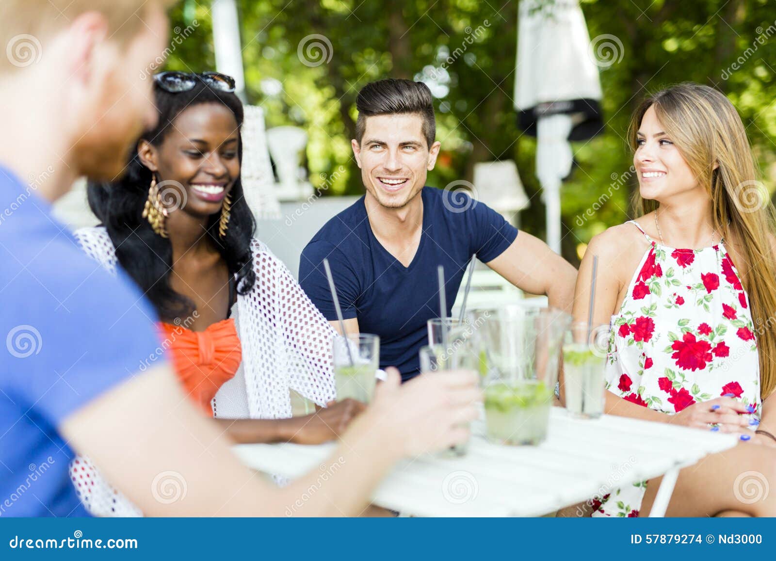 Young and Happy Friends Sitting Talking at a Table Stock Photo - Image ...