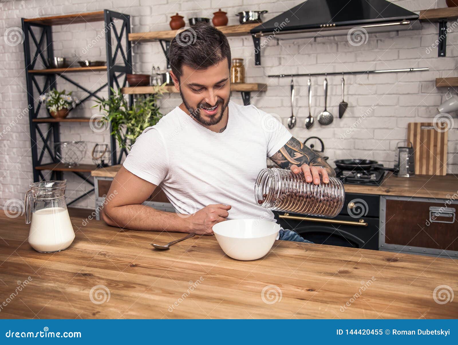Young Happy Handsome Smiling Guy is Preparing His Breakfast at the ...