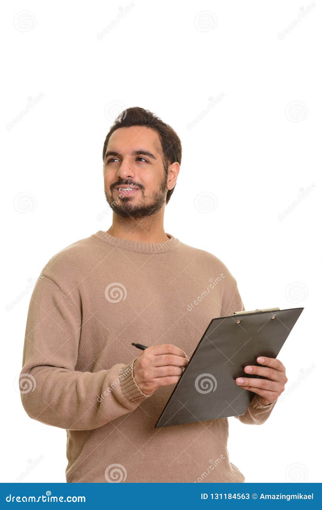 Young Happy Indian Man Writing Report on Clipboard while Thinkin Stock ...