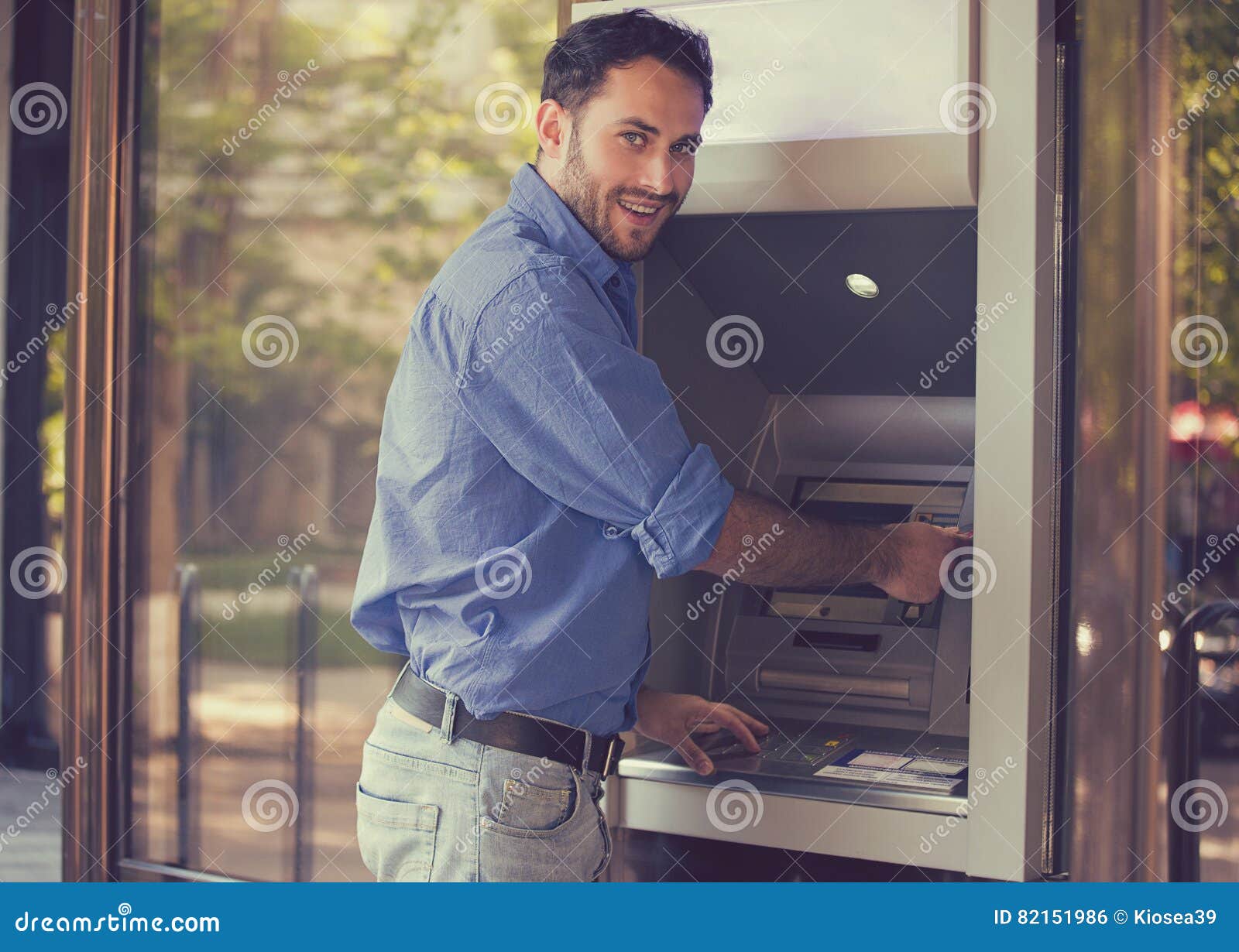 Young happy man using ATM stock photo. Image of hand - 82151986