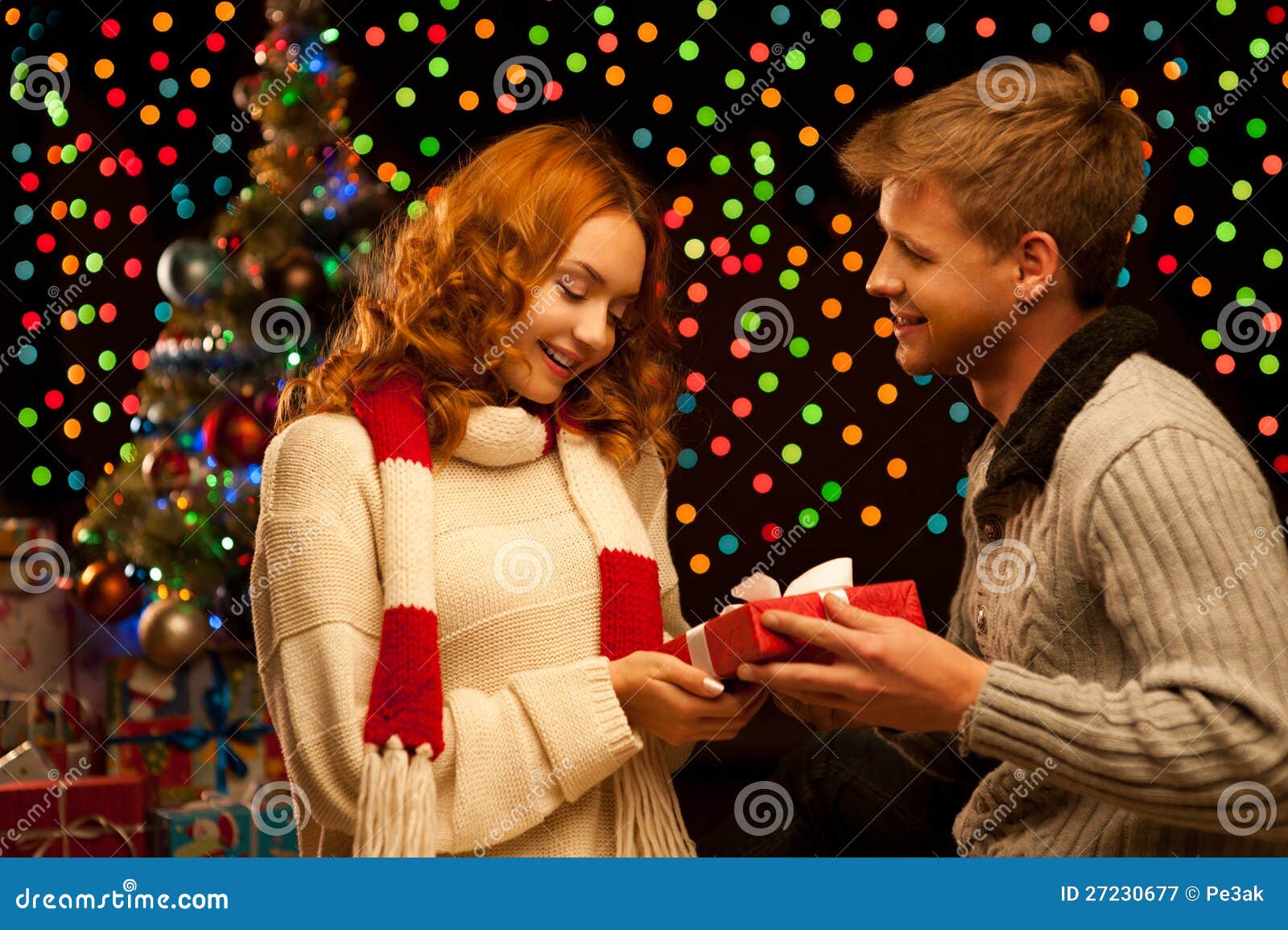Young Happy Smiling Casual Couple Making a Present Stock Image - Image ...