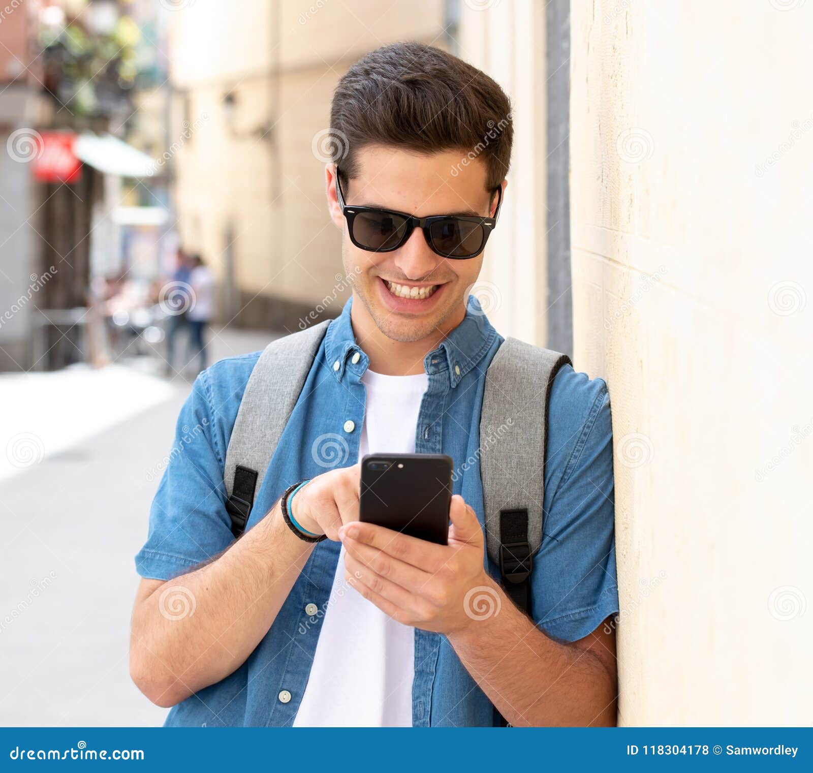 Happy Young Student Male Texting on His Smart Phone in Modern Ci Stock ... Happy Young Student Male Texting on His Smart Phone in Modern Ci Stock ...