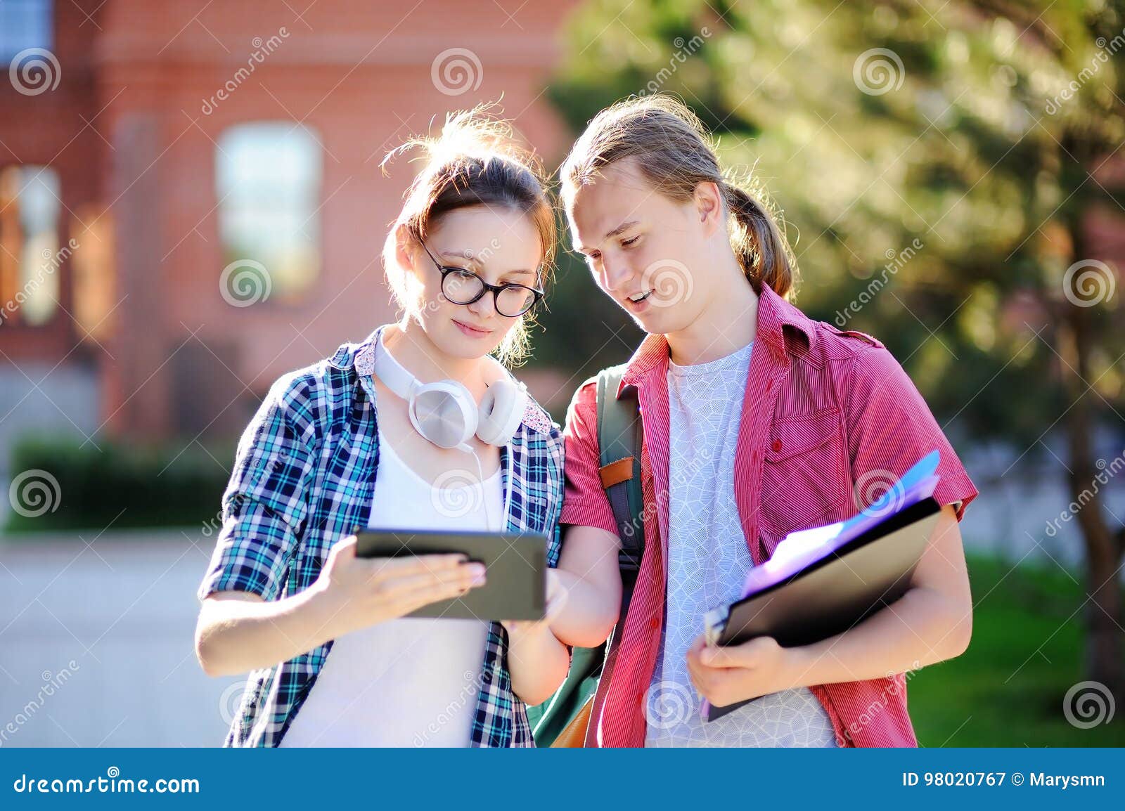 Young Happy Students with Books and Notes in University Campus Stock ...