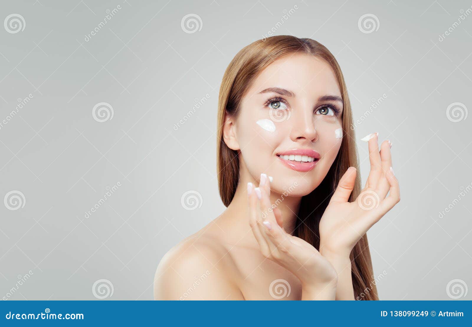 Young Happy Woman With Healthy Skin Applying Cosmetic Cream Skincare