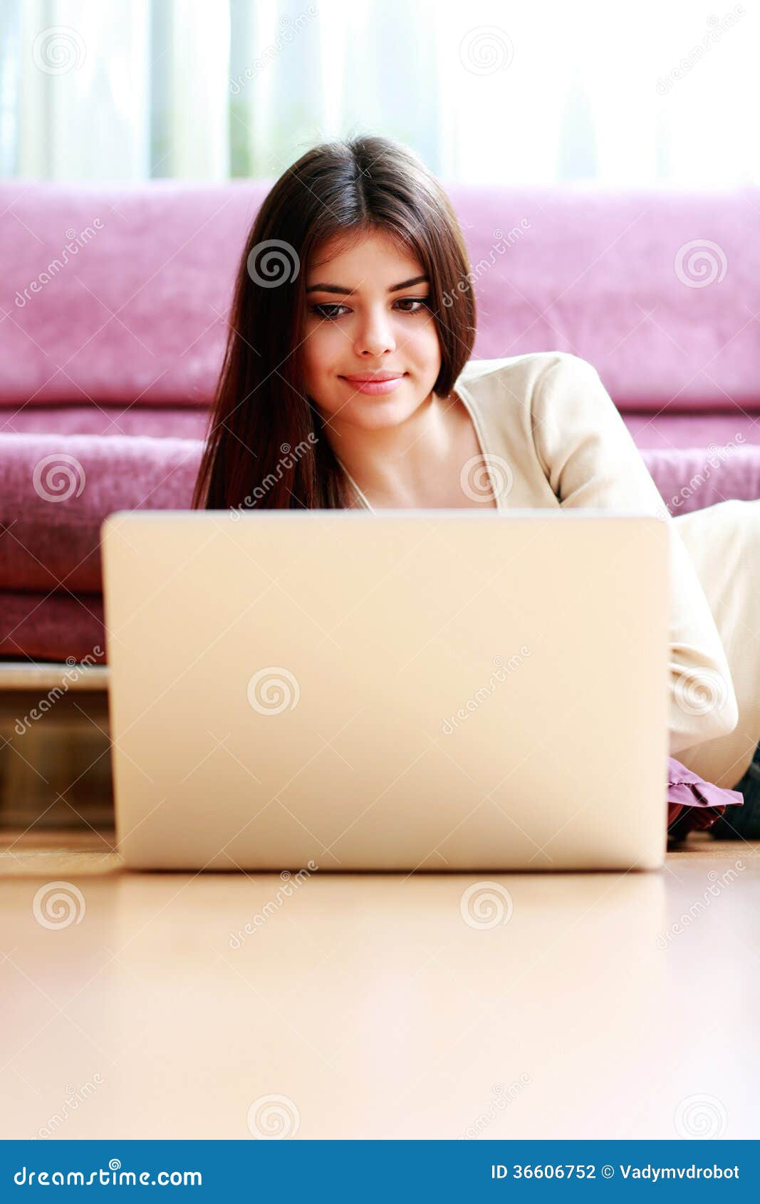 Young Happy Woman Lying on the Floor and Using Laptop Stock Photo ...