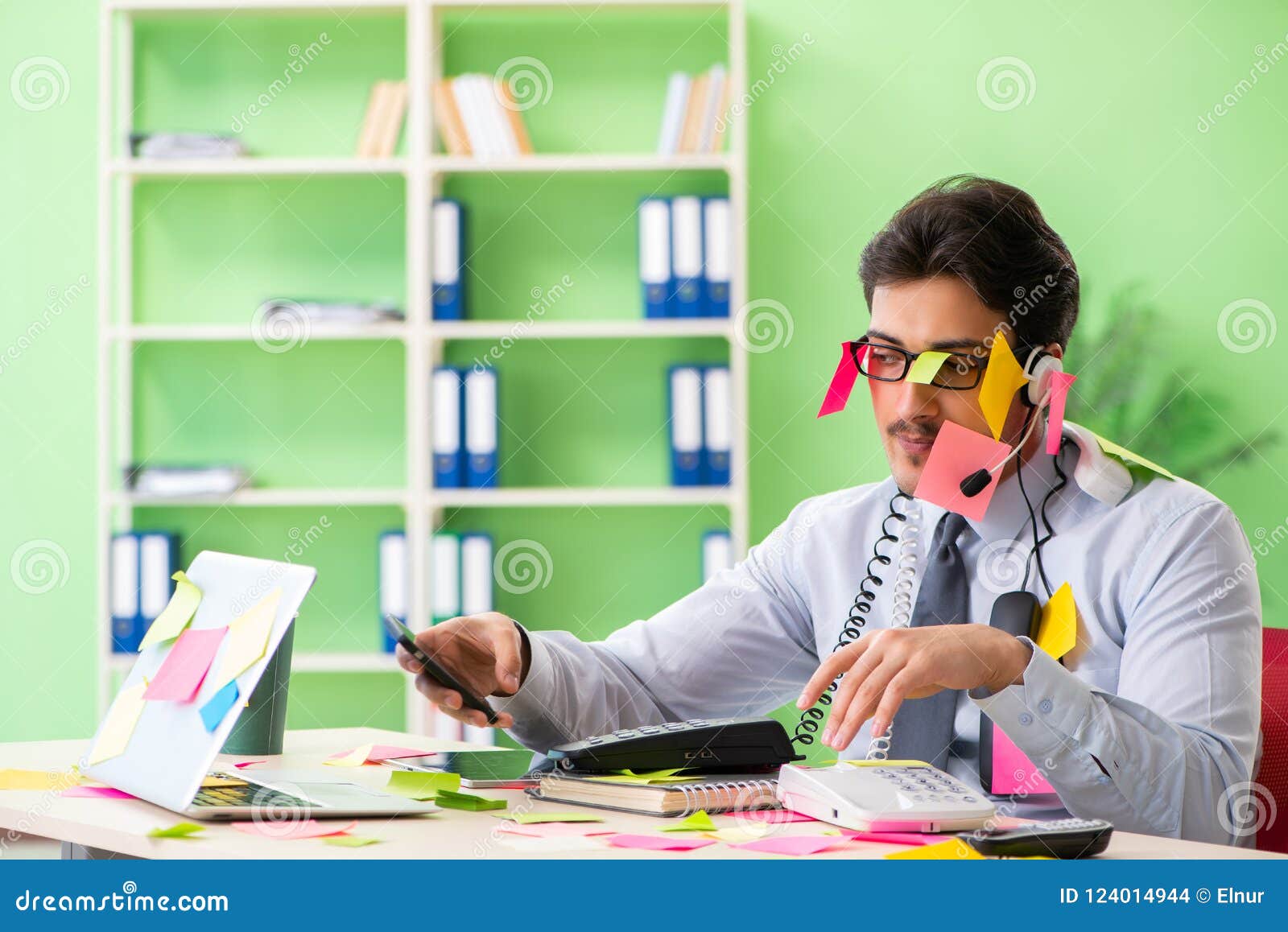 The Young Help Desk Operator Working in Office with Many Conflicting ...