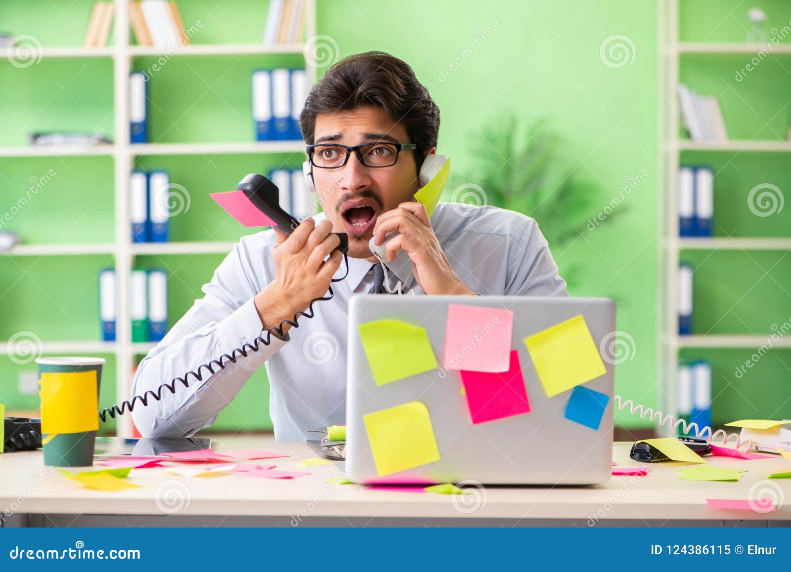 Young Help Desk Operator Working in Office with Many Conflicting Stock ...