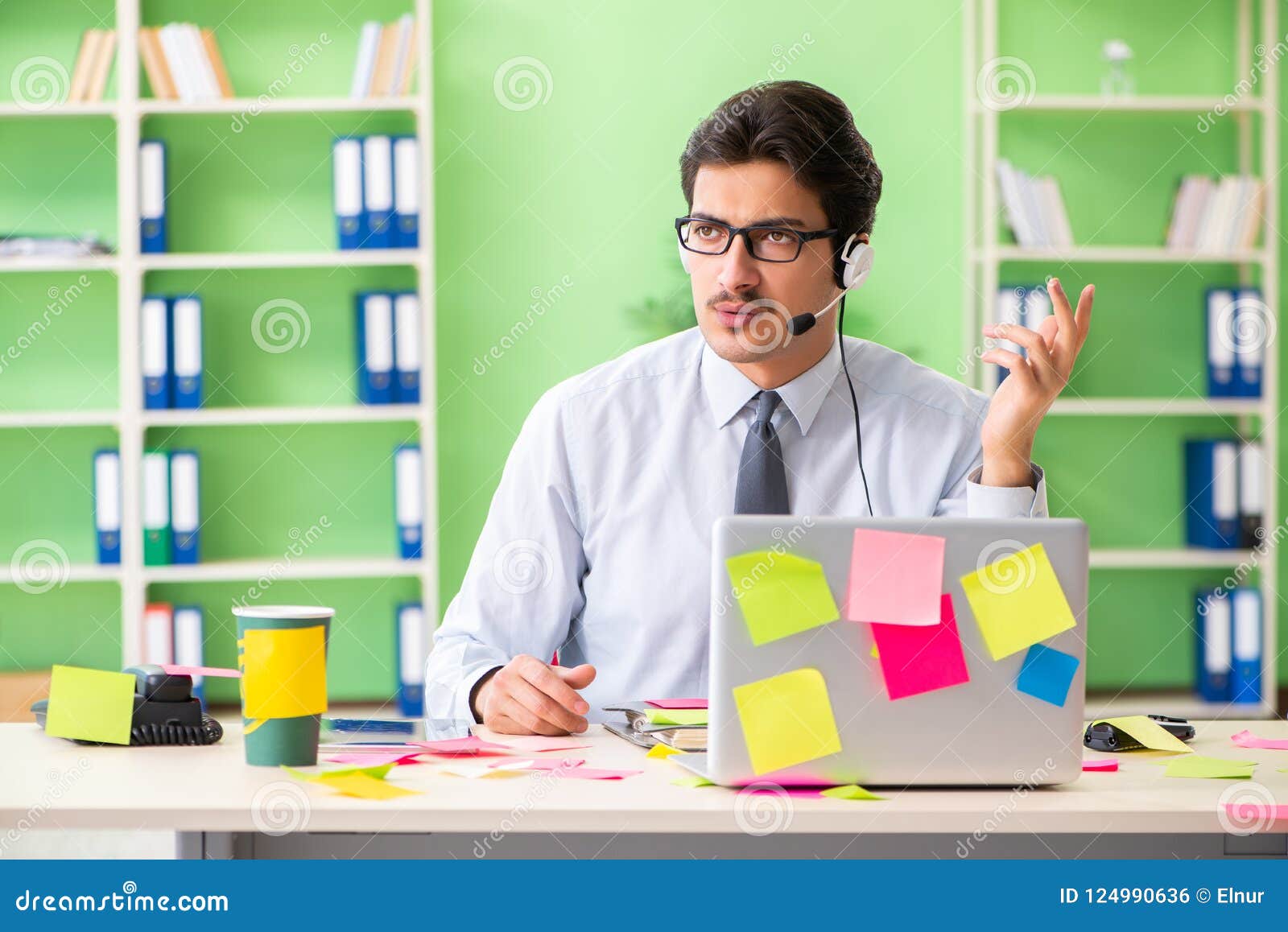 Young Help Desk Operator Working in Office with Many Conflicting Stock ...