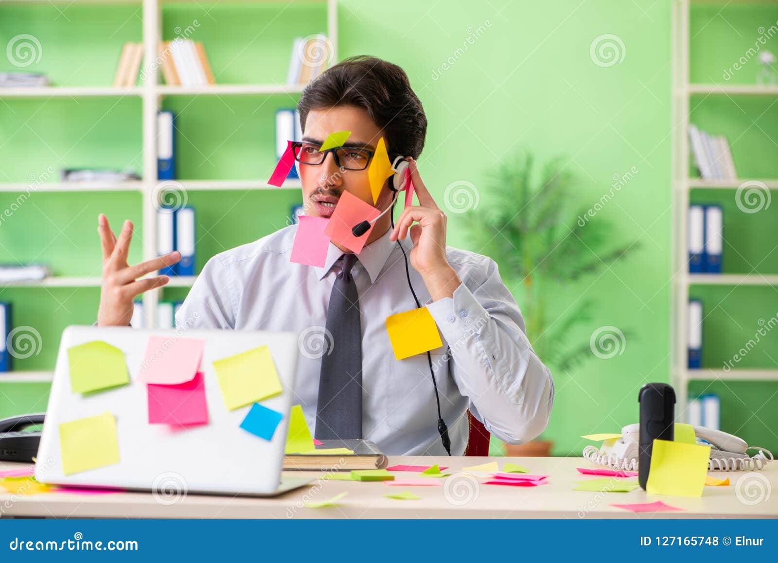 Young Help Desk Operator Working in Office with Many Conflicting Stock ...