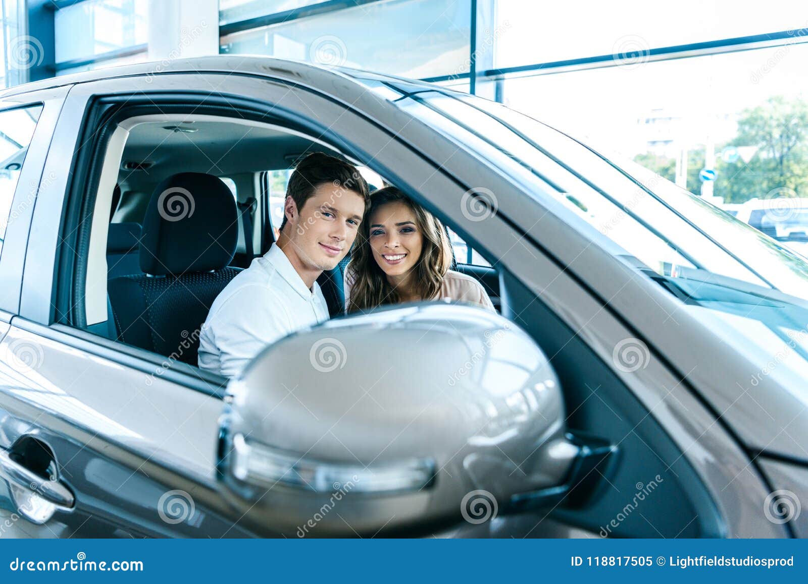 Young Heterosexual Couple Riding On Scary Merry Go Rounds In An
