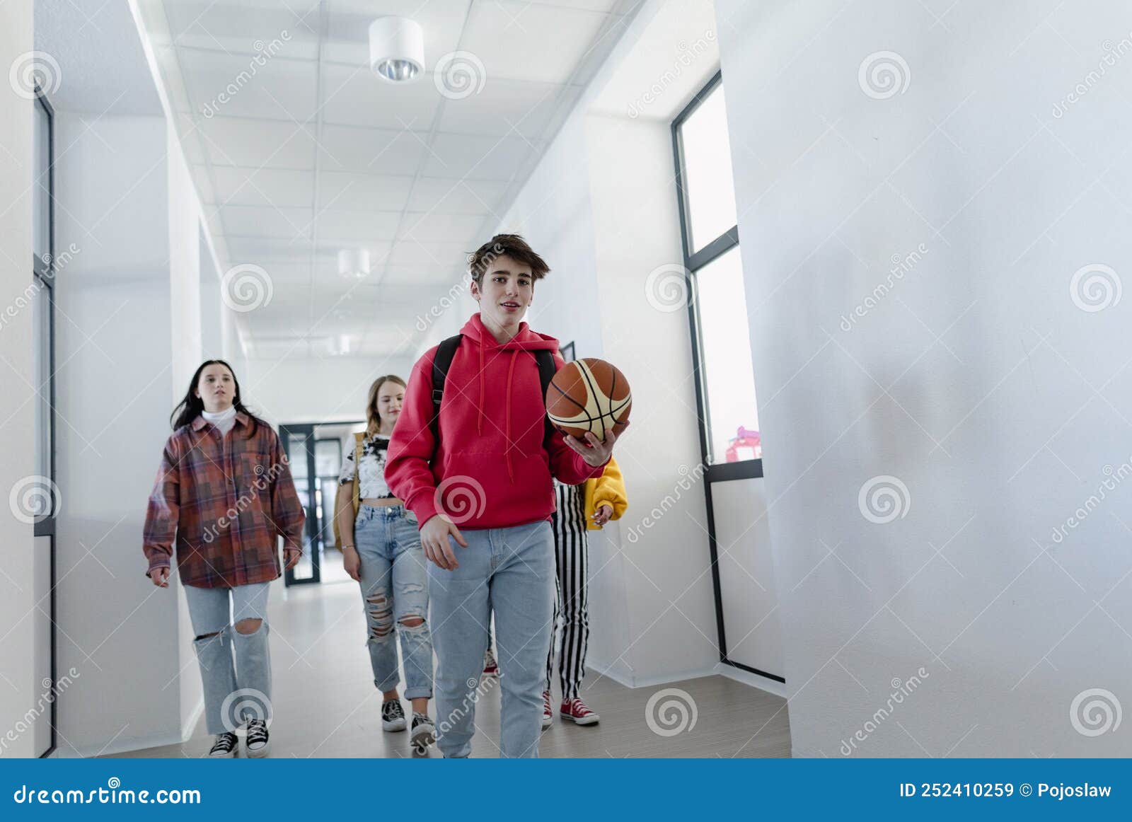 Young High School Students Walking in Corridor at School, Back To ...
