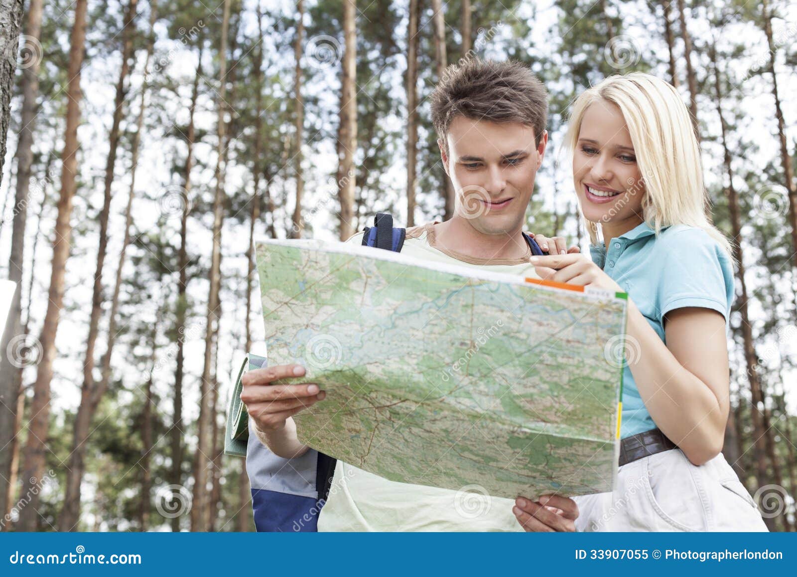 Young Hiking Couple Reading Map In Forest Stock Image Image Of