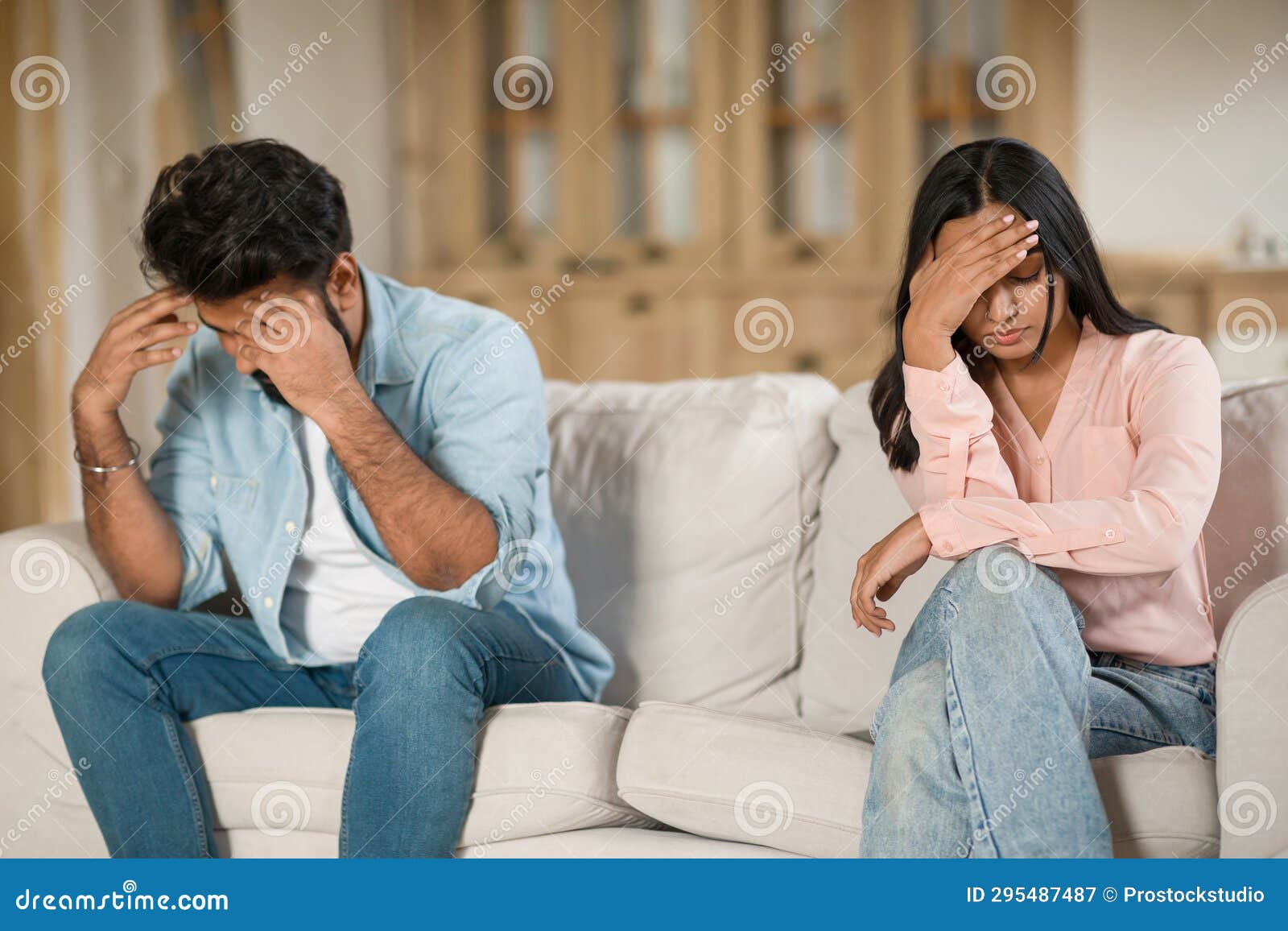 Young Hindu Spouses Distressed, Sitting Apart at Home on Sofa Stock ...