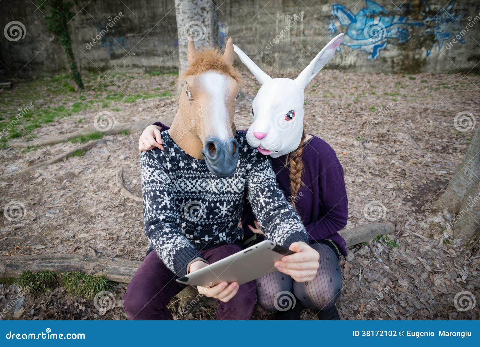 Young Hipster Cuople Horse and Rabbit Mask Using Tablet Stock Photo ...