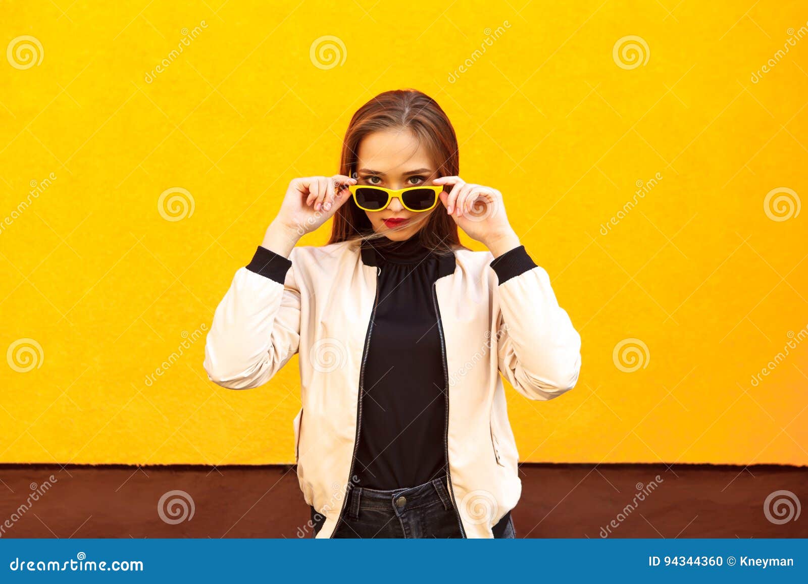 Young Hipster Girl Holding Yellow Sunglasses on Orange Wall. Urban ... Young Hipster Girl Holding Yellow Sunglasses on Orange Wall. Urban ...