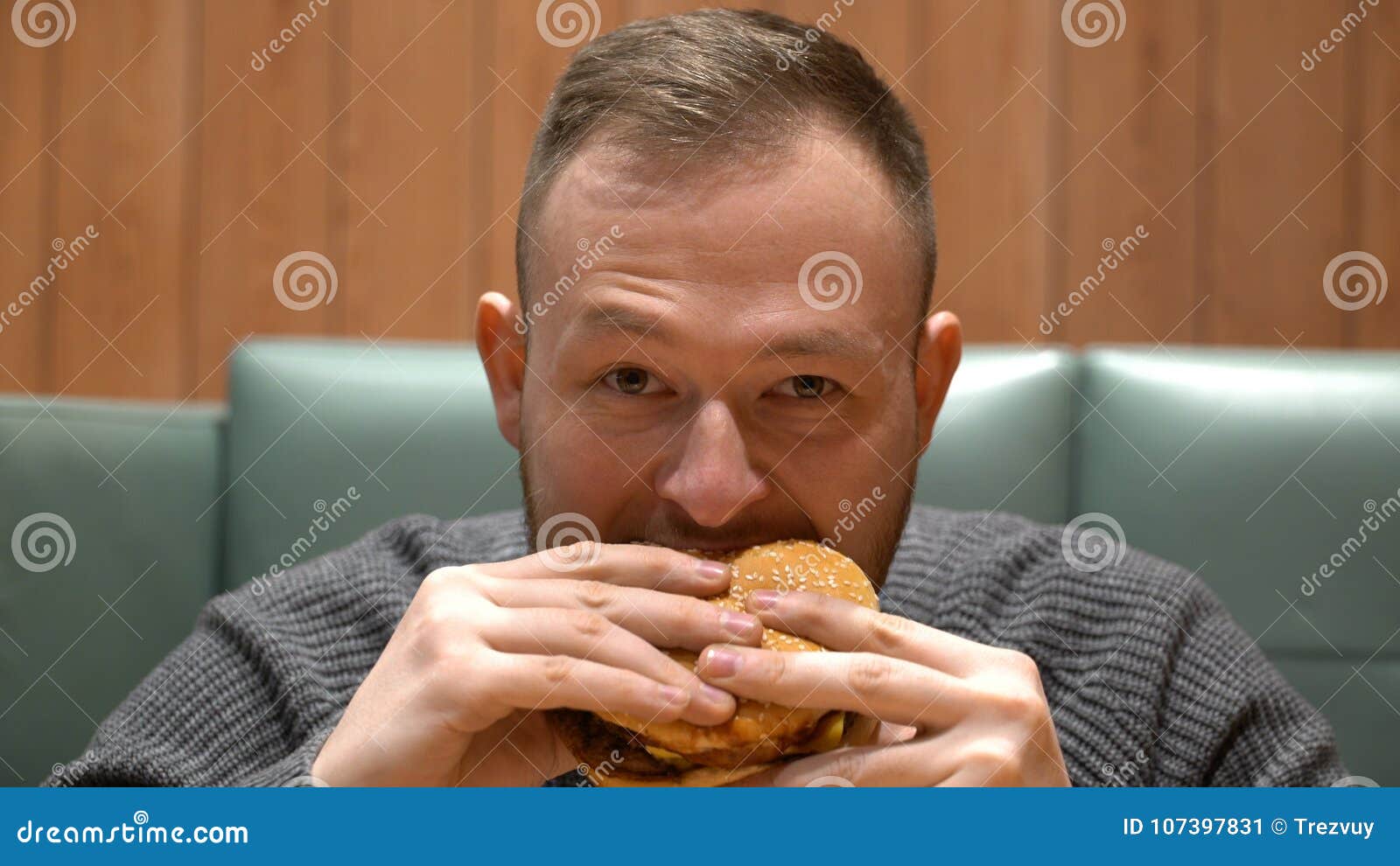 Young Hipster Guy Eating Burger Sitting in Cafe Stock Image - Image of ...