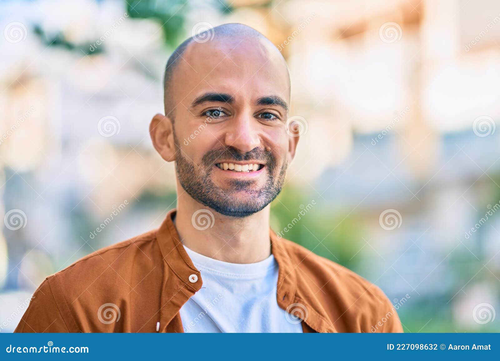 Young Hispanic Bald Man Smiling Happy Standing at the City Stock Photo ...