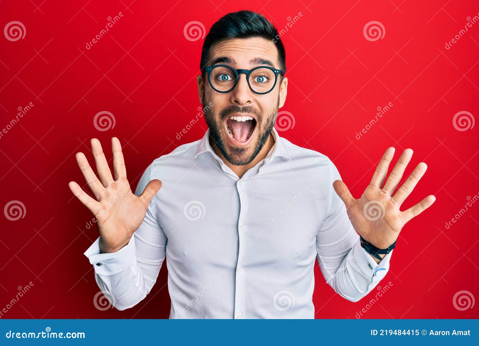 Young Hispanic Businessman Wearing Shirt And Glasses Celebrating Crazy