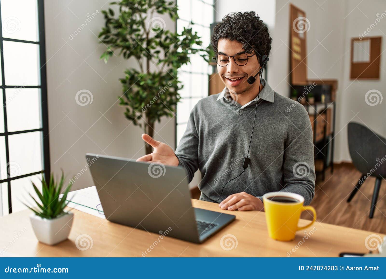 Young Hispanic Call Center Agent Man Having Video Call at the Office ...